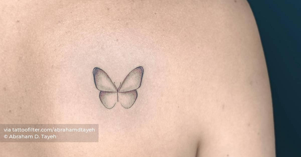 Delicate butterfly tattoo located on the shoulder