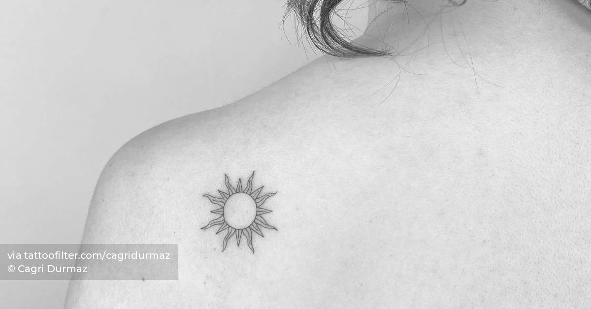 Fine line sun tattoo done on the shoulder blade.