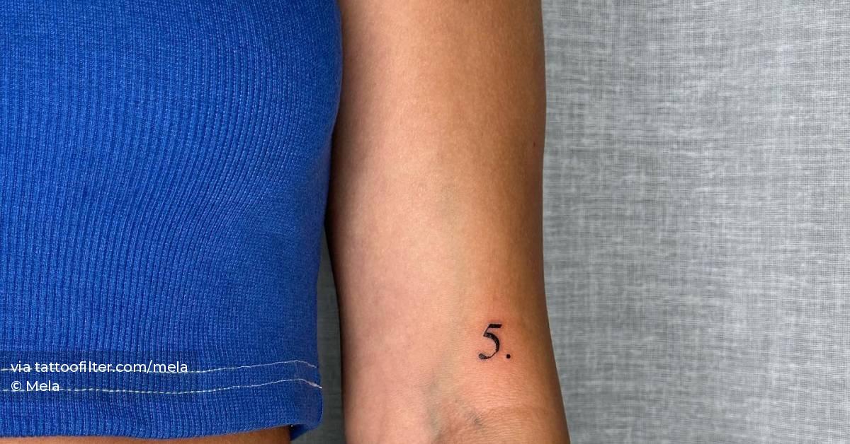Tattoo of the number "5" located on the bicep.