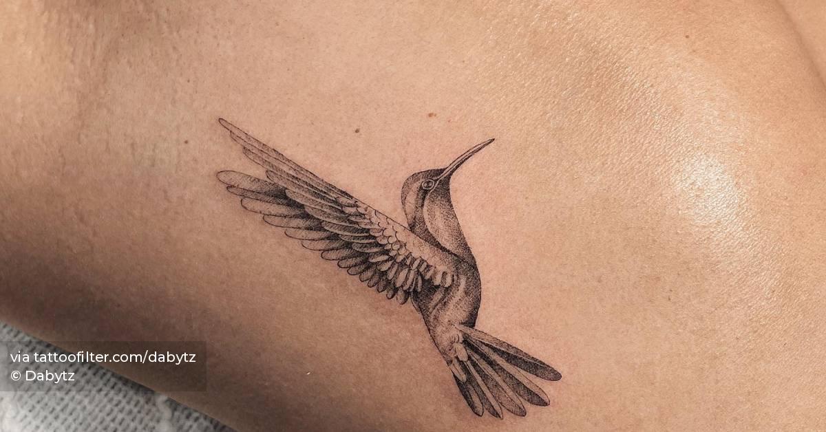 Hummingbird tattoo placed on the rib, micro-realistic