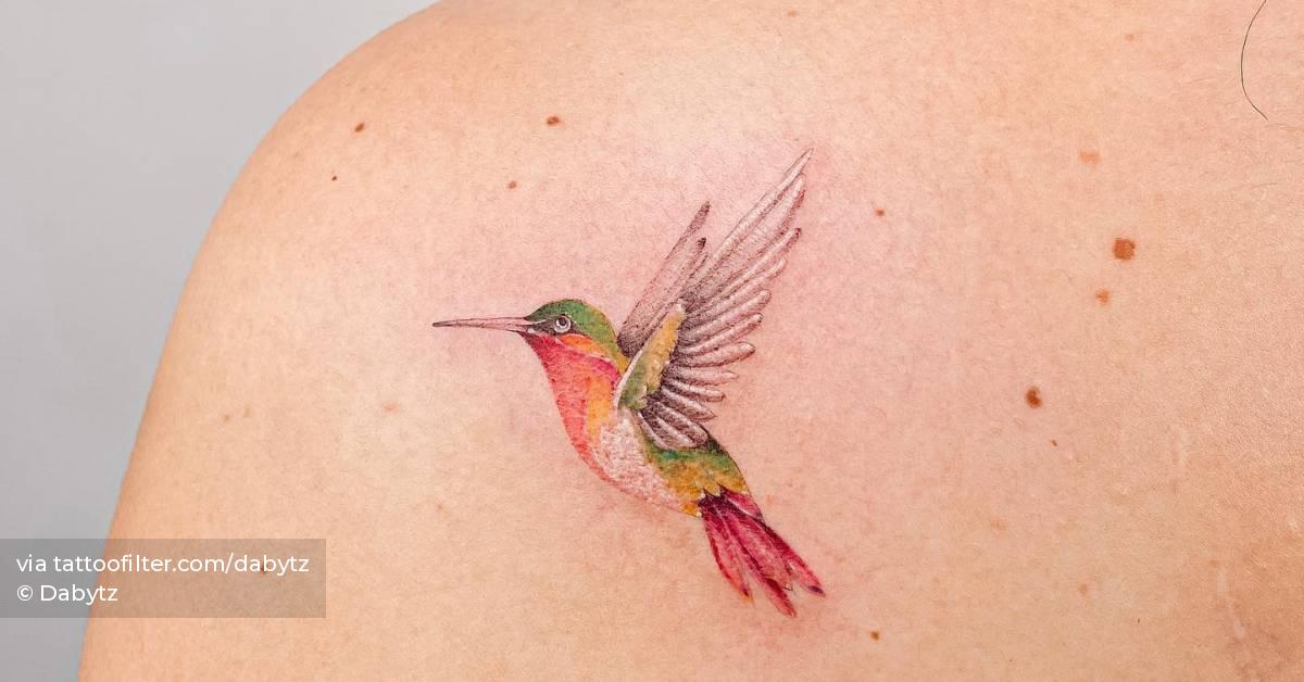 Colorful hummingbird tattoo done on the shoulder blade.