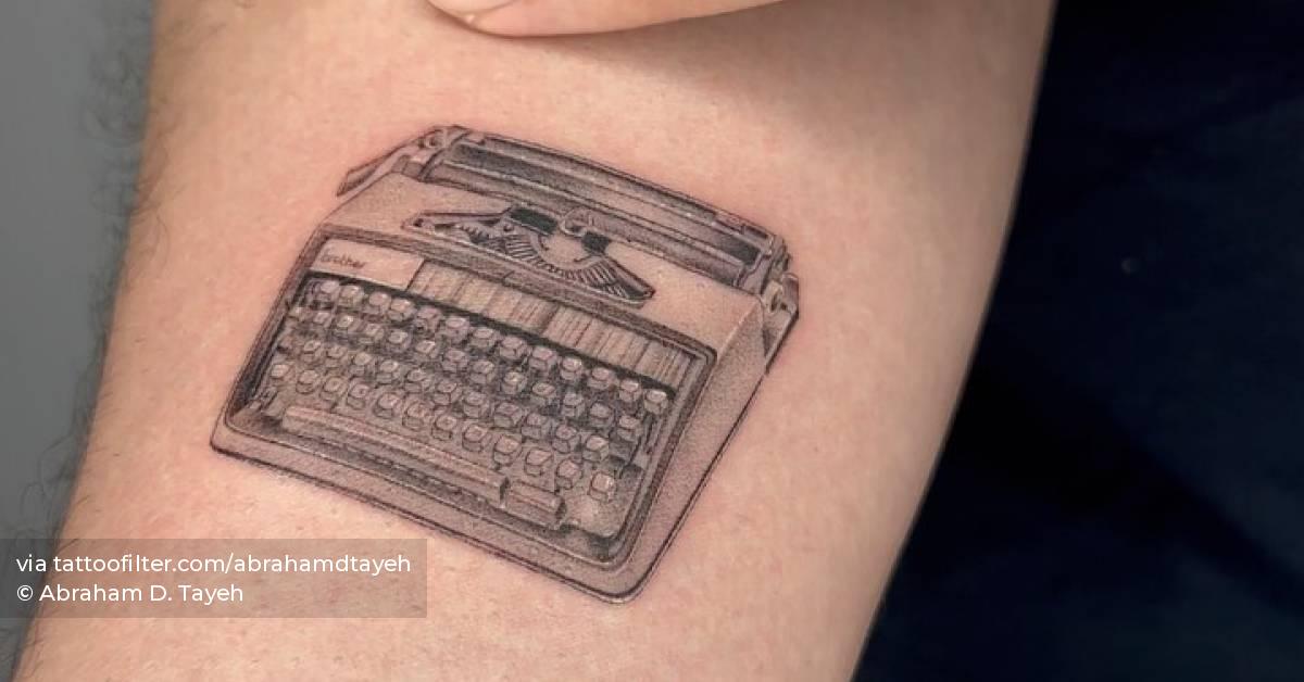 Micro-realistic typewriter tattoo placed on the inner