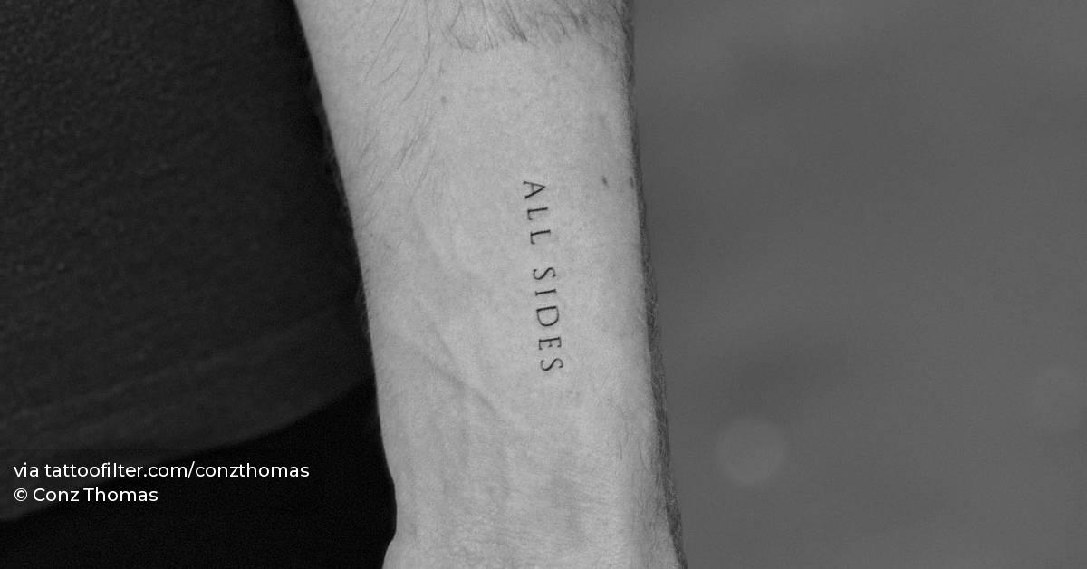 "All sides" lettering tattoo located on the wrist.