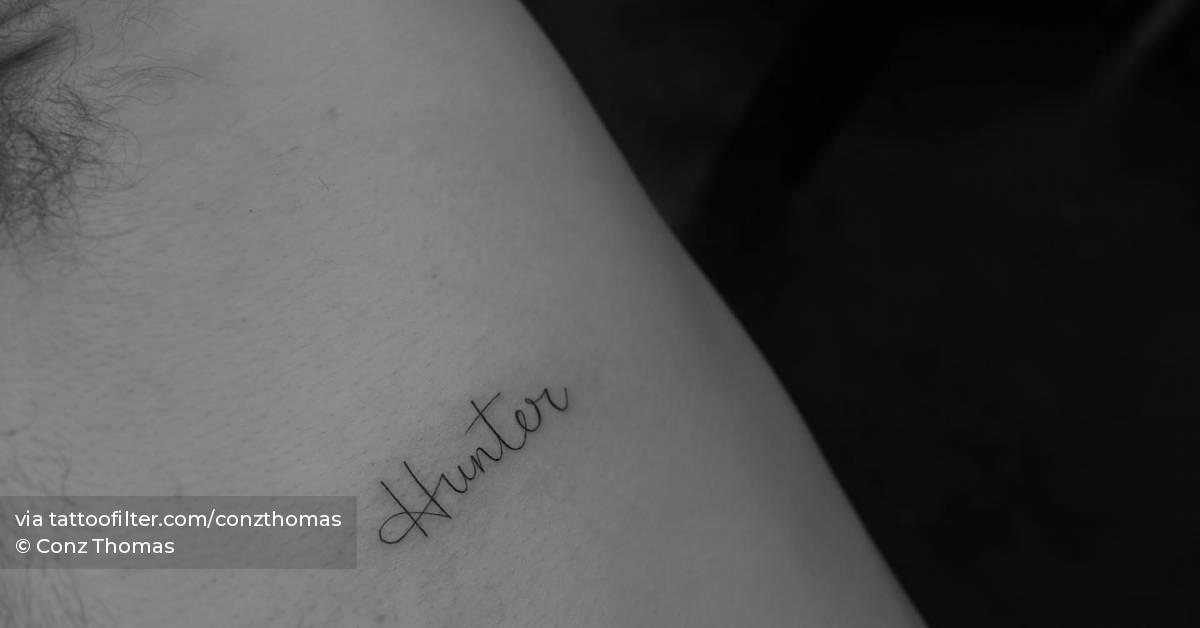 "Hunter" lettering tattoo located on the rib.