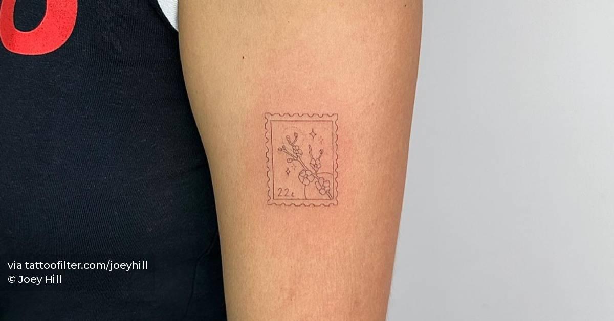 Flower stamp tattoo located on the upper arm, fine line