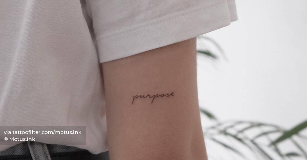 Word "purpose" tattooed on the tricep.