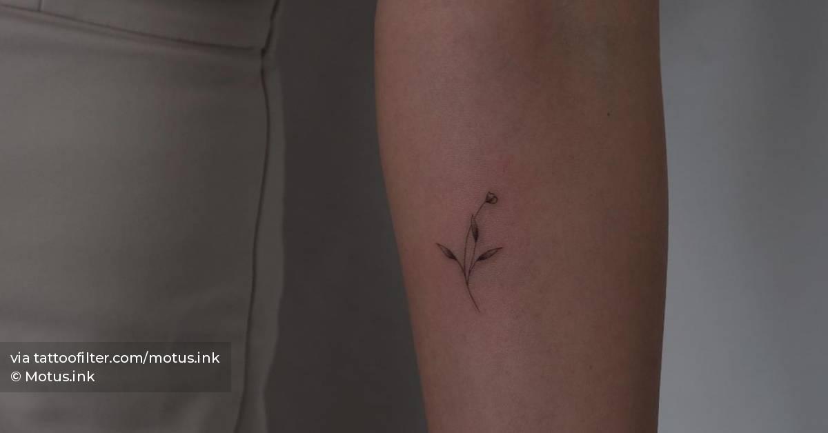 Minimalistic flower tattoo located on the inner
