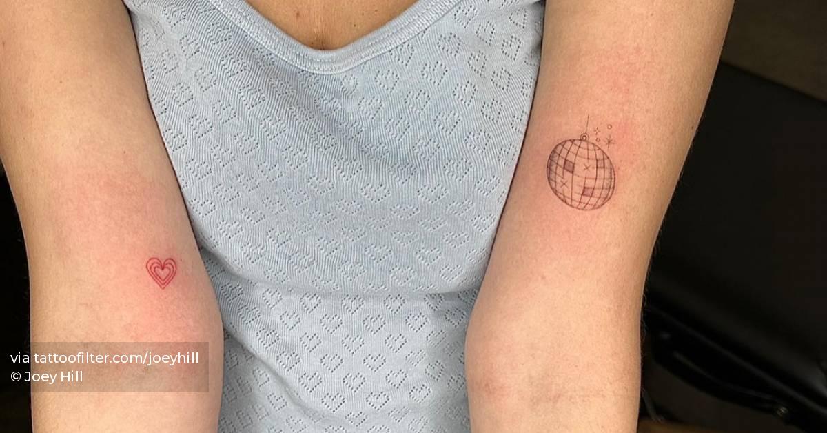 Red heart and disco ball tattoo located on the inner
