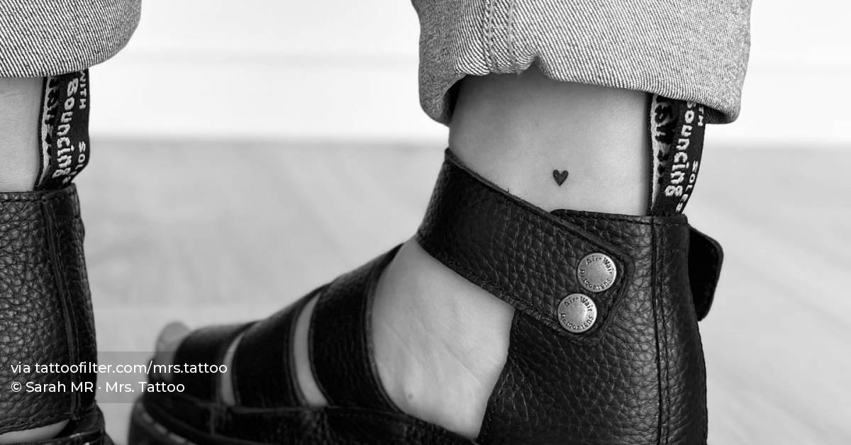 Micro heart tattoo located on the ankle, minimalistic