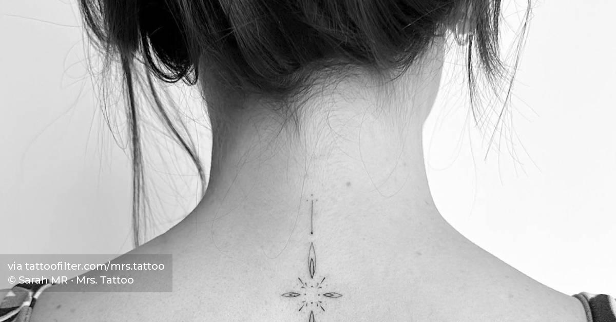 Fine line ornament tattoo placed on the upper back.