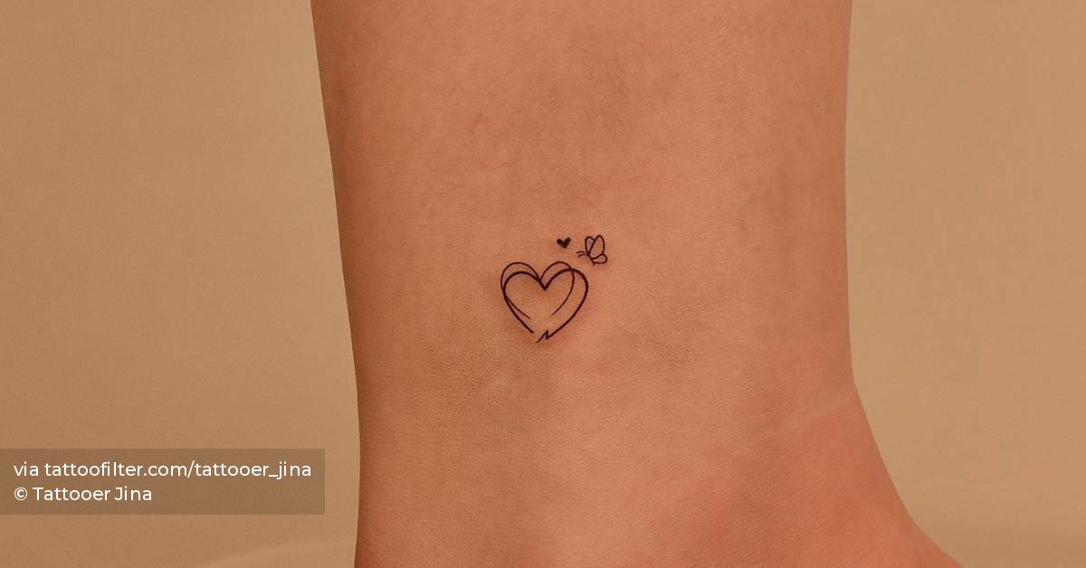Fine line style heart and butterfly tattoo located on