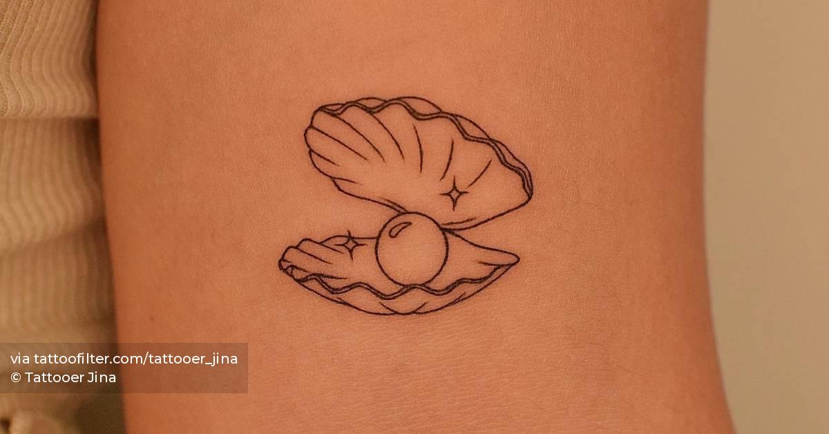 Fine line style scallop shell tattoo done on the bicep.