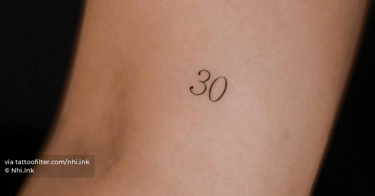 Little tatto of the number "30" located on the inner