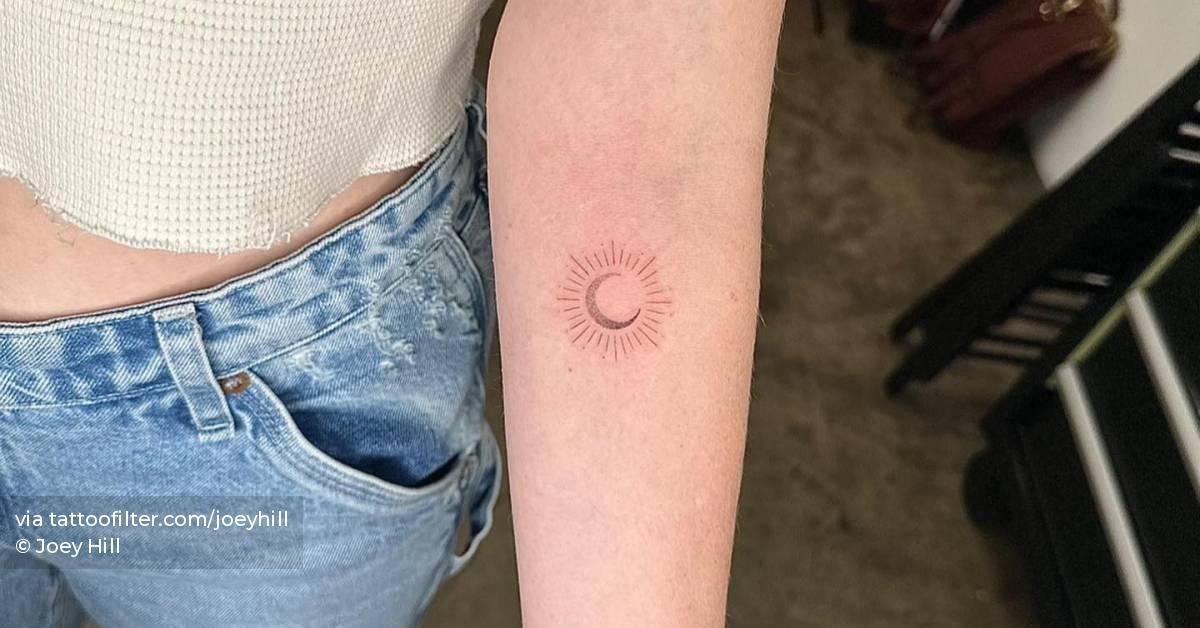 Eclipse tattoo located on the inner forearm,