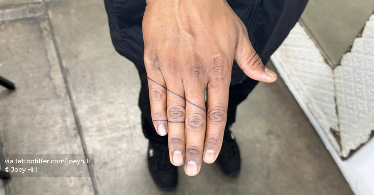 Minimalistic style line tattoo located on the fingers.