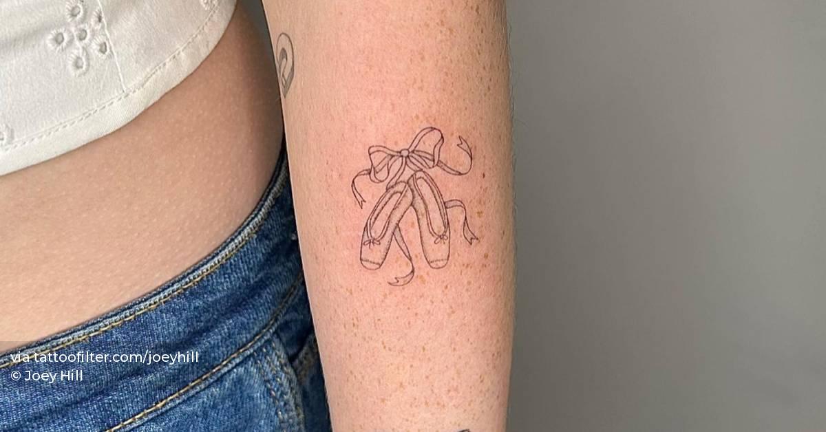 Fine line ballet shoes and ribbon tattoo placed on the