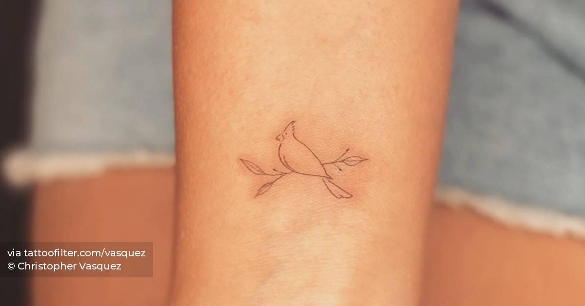 Fine line style cardinal tattoo located on the wrist.
