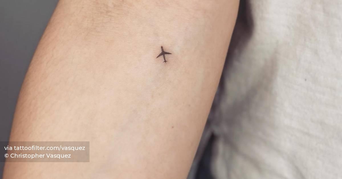 Tiny minimalistic airplane tattoo placed on the inner