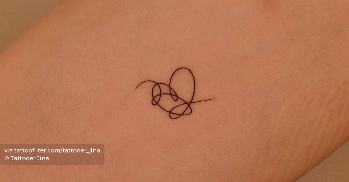 BTS heart tattoo located on the inner forearm.