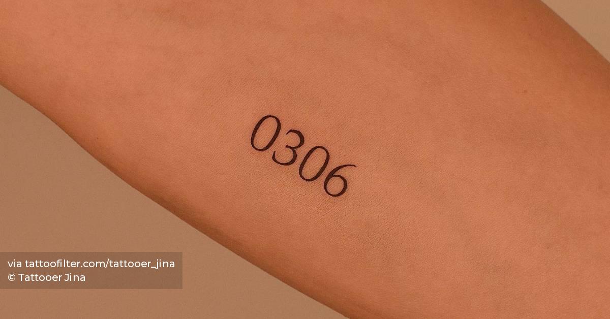 Number "0306" tattooed on the inner forearm.