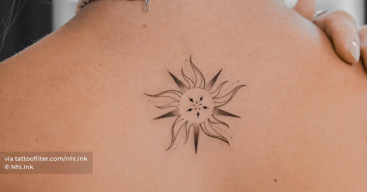 Sun tattoo located on the upper back, illustrative