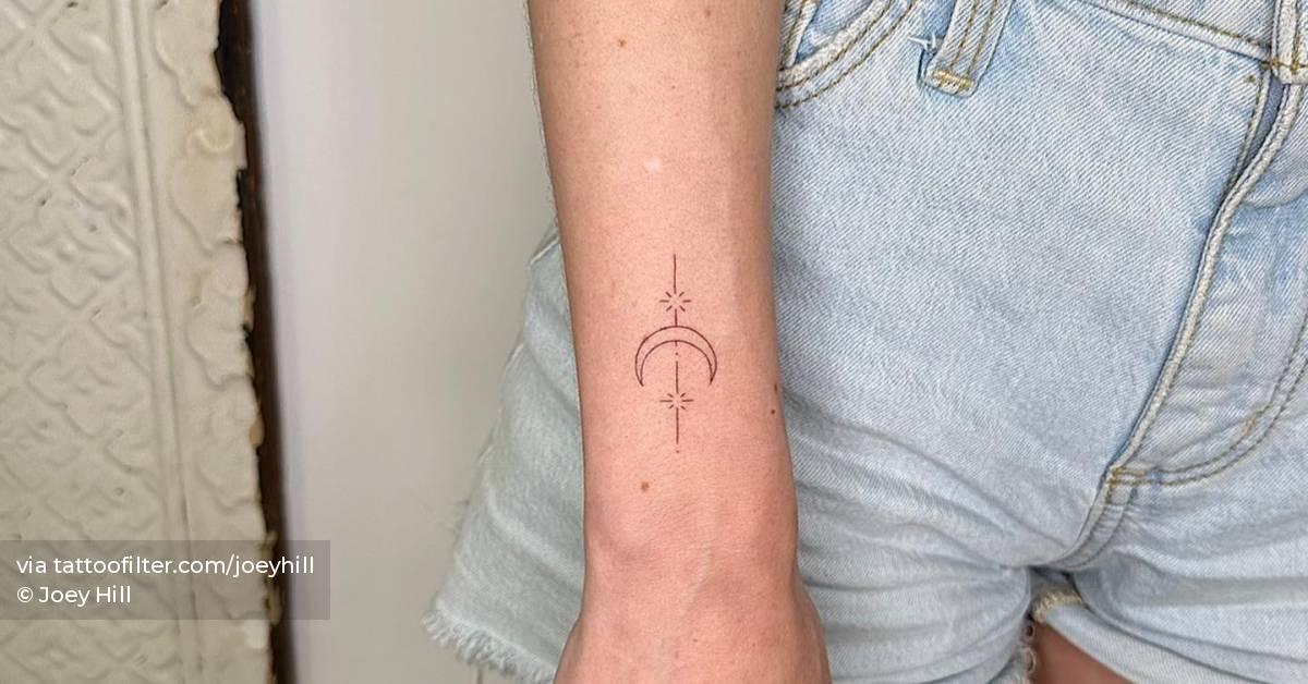 Fine line style stars and moon ornament tattooed on the