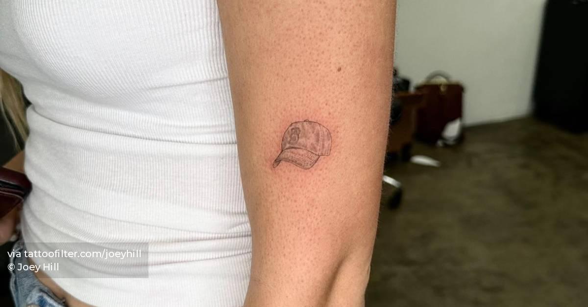 Single needle trucker cap tattoo located on the upper