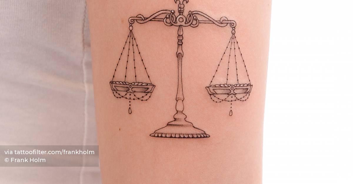 Scale tattoo located on the upper arm, illustrative