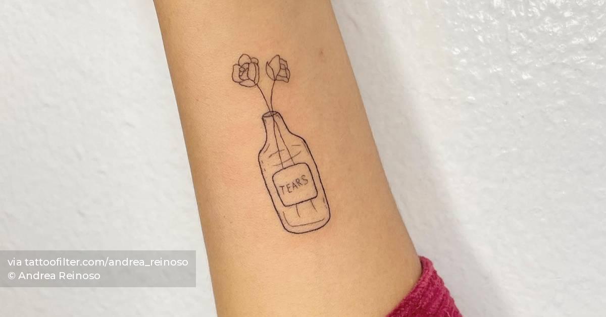 Fine line style flowers in a bottle tattoo done on the