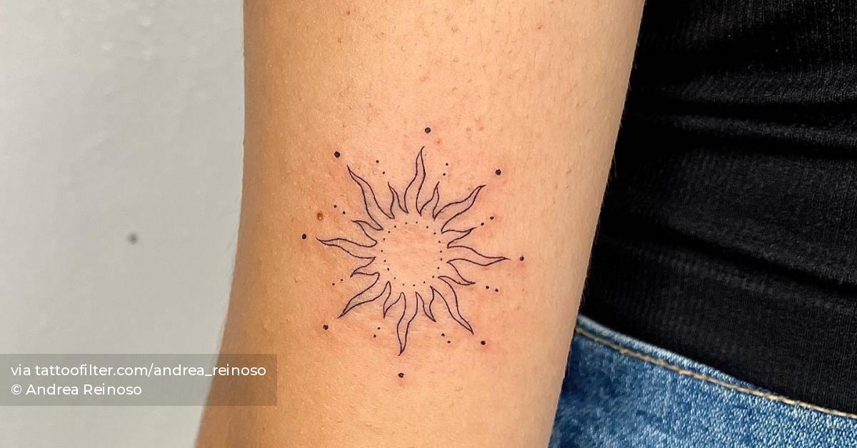 Sun tattoo placed on the tricep, fine line style.