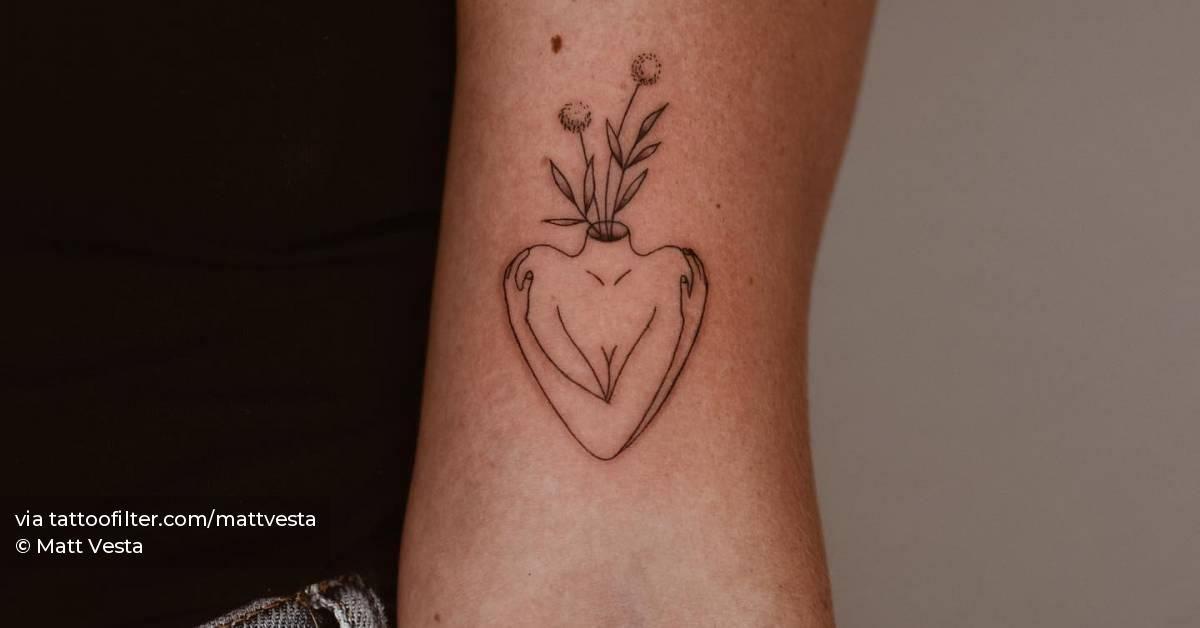 Self hug tattoo placed on the bicep, fine line style.