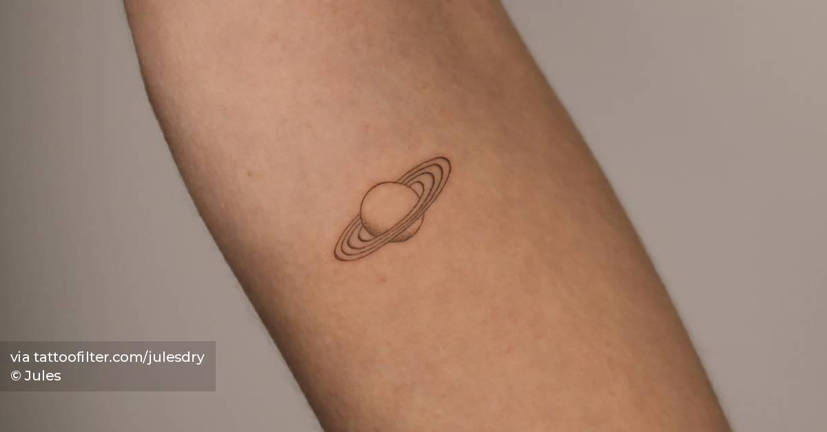 Fine line Saturn tattoo done on the inner forearm.