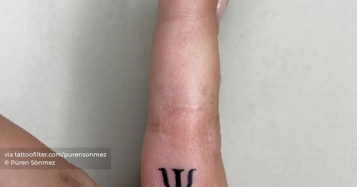 Minimalist psi letter tattoo on the finger.