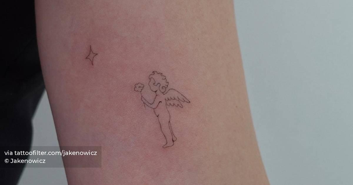 Little cherub tattoo located on the bicep, fine line