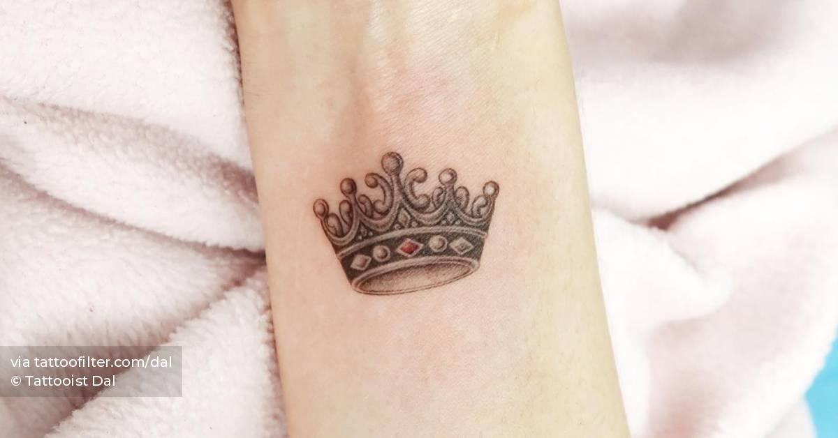 Illustrative style crown tattoo located on the wrist.