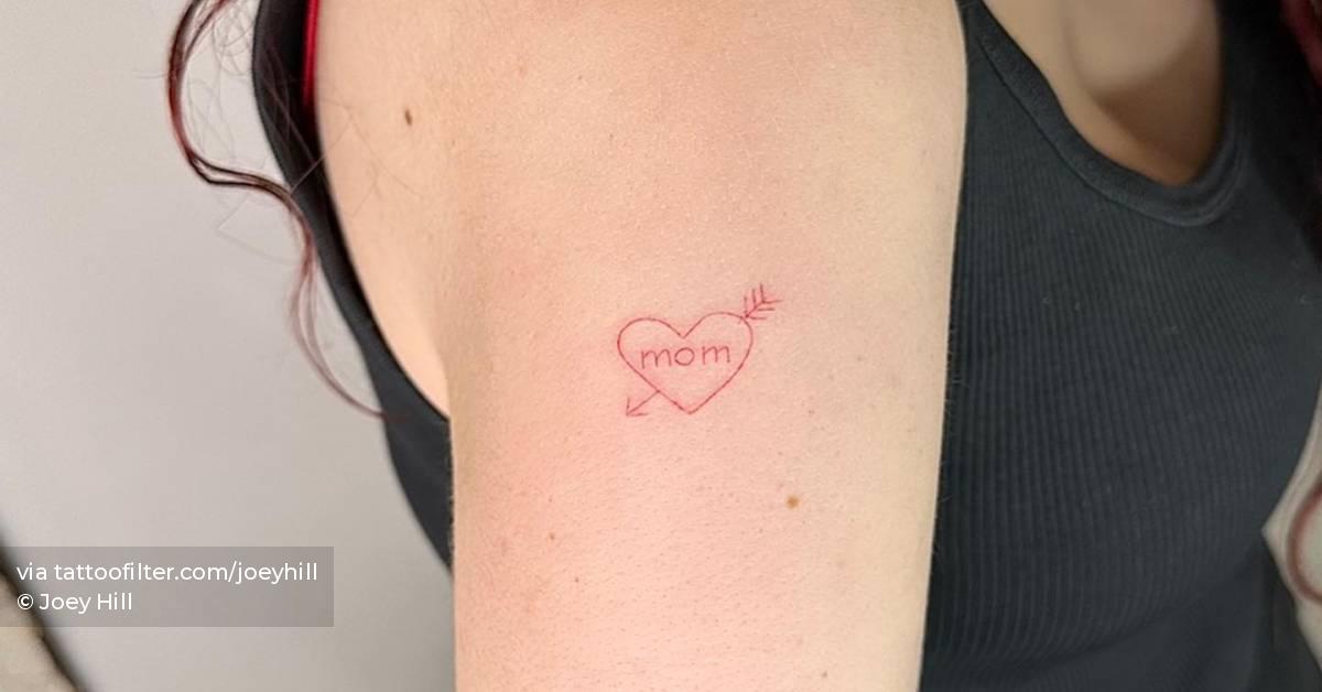 Fine line red heart and arrow tattoo located on the