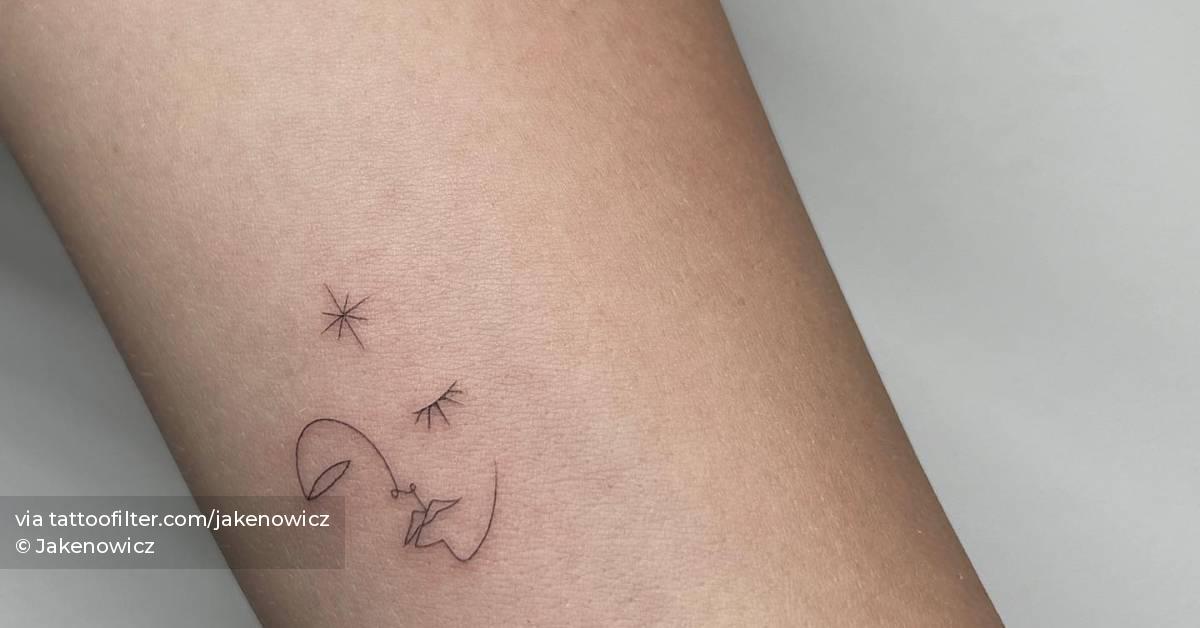 Face and word "focus" tattooed on the inner forearm.