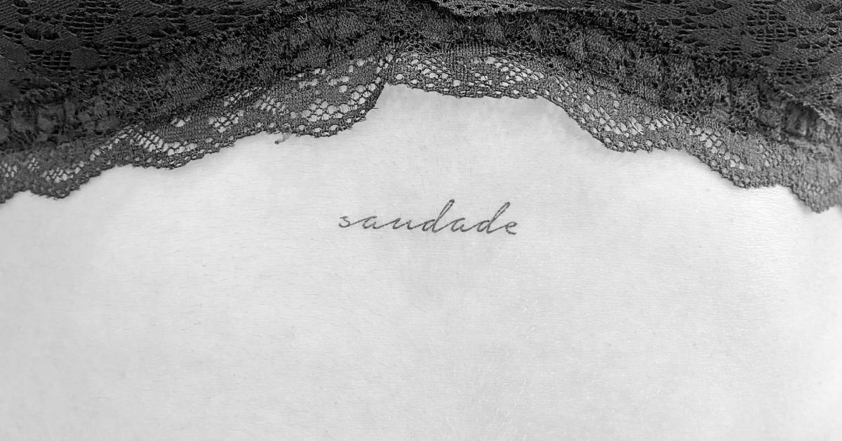 Saudade Temporary Tattoo located on the stomach.