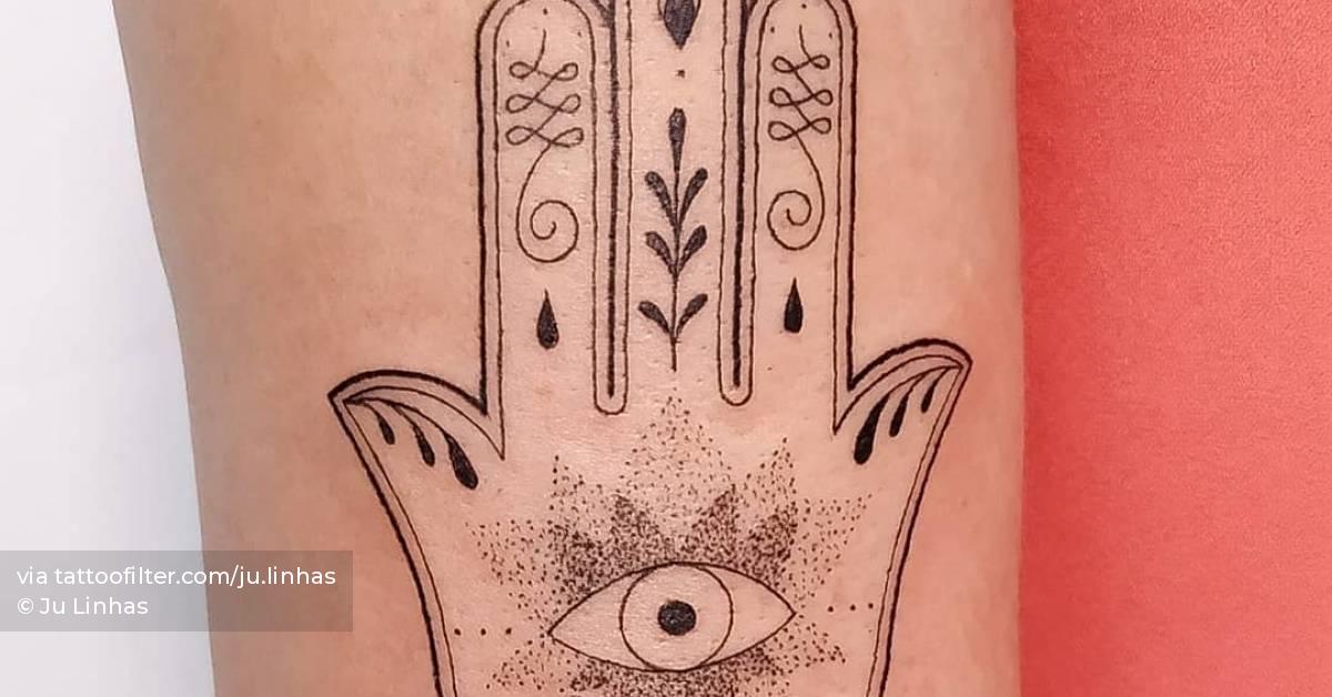 Hamsa tattoo done on the tricep.
