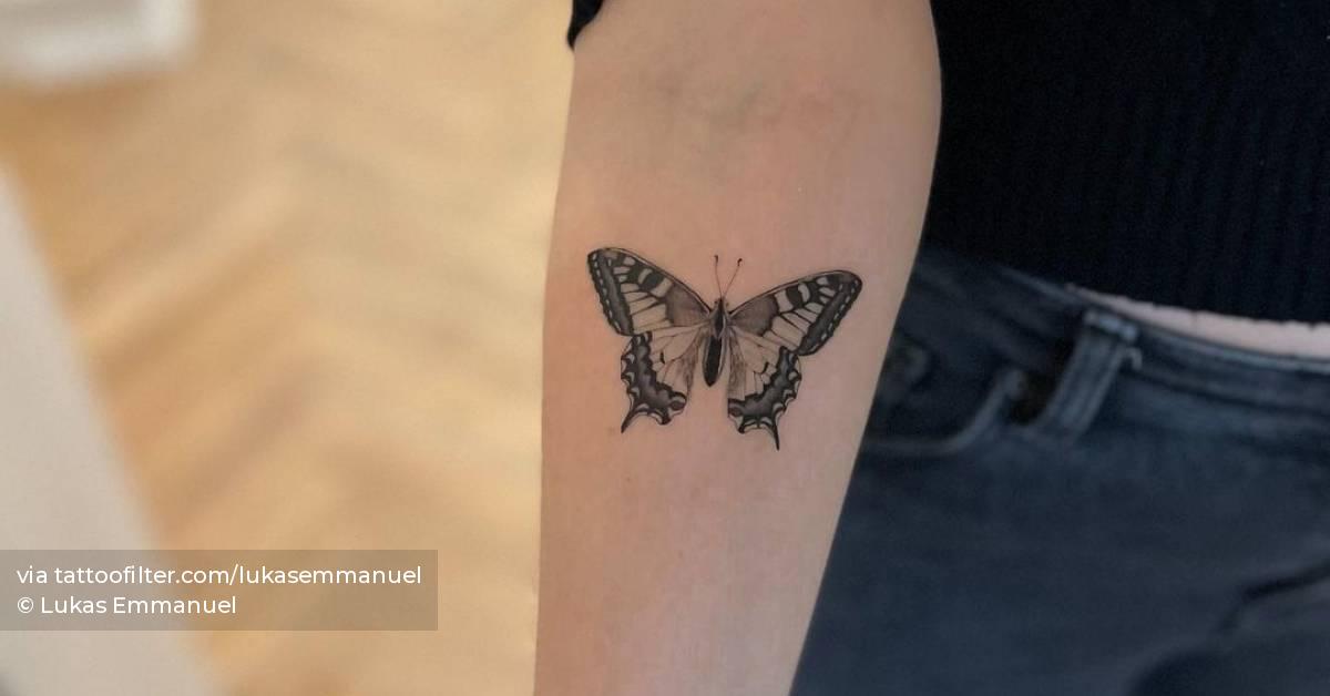 Micro-realistic butterfly tattoo located on the inner