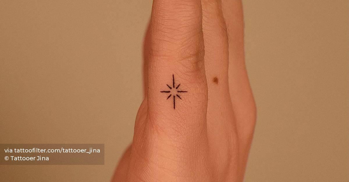 Tiny star tattoo located on the finger, minimalistic