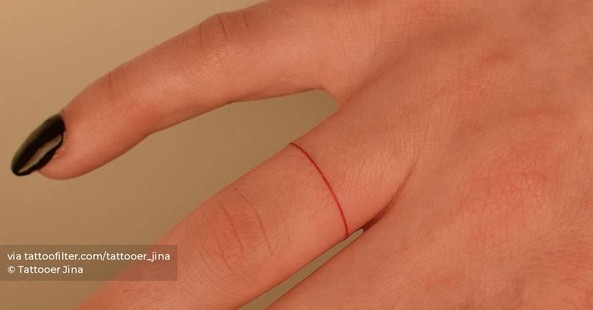 Minimalistic red ring tattoo.