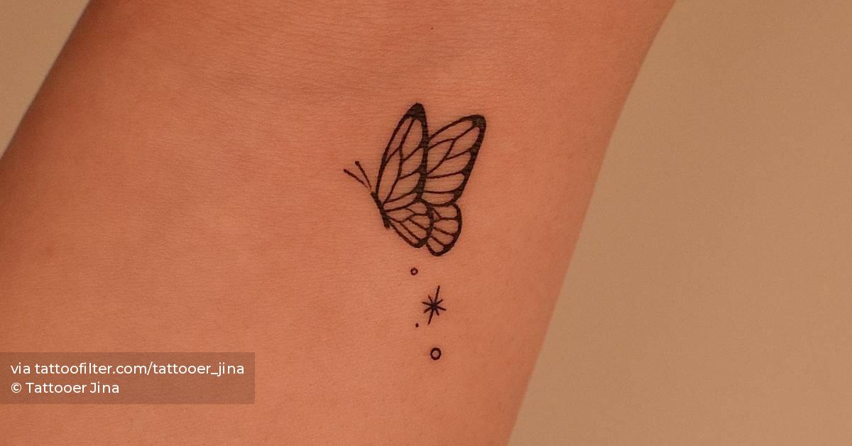 Fine line butterfly tattoo placed on the wrist.