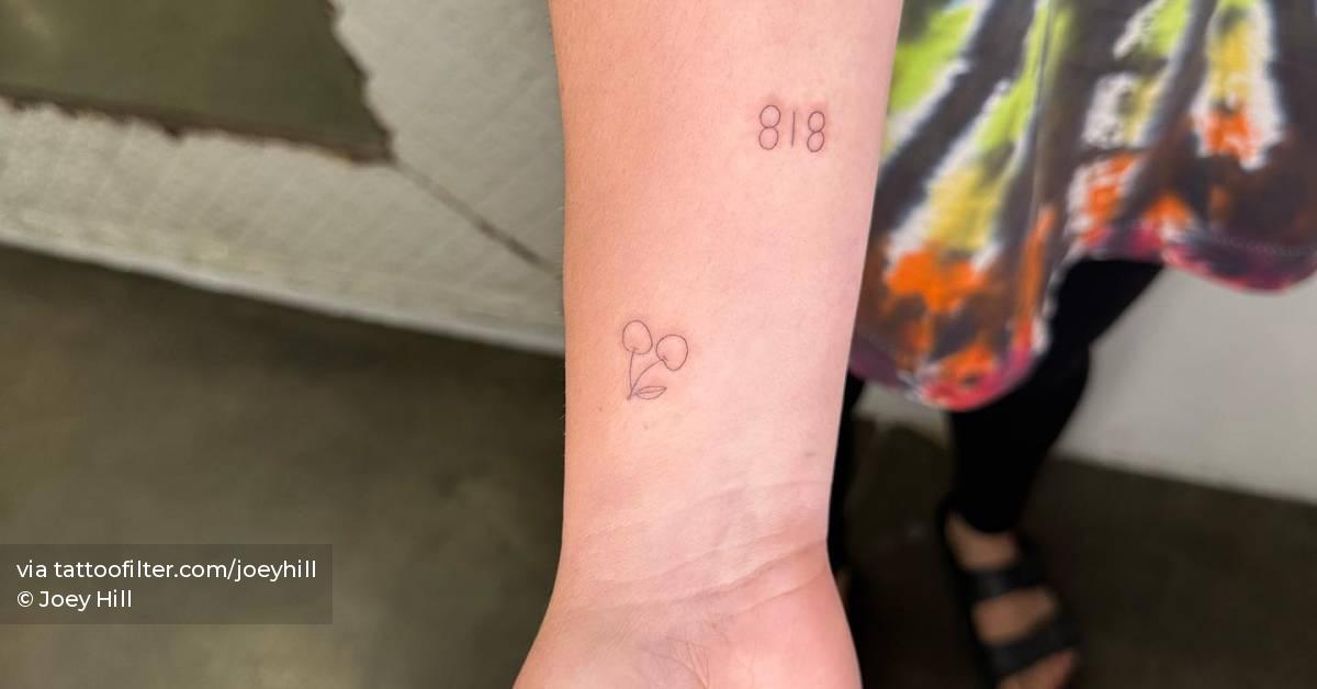 Fine line cherry and number "818" tattooed on the inner