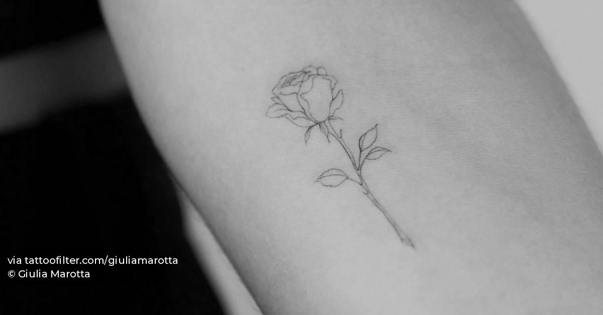 Fine line style rose tattoo located on the inner