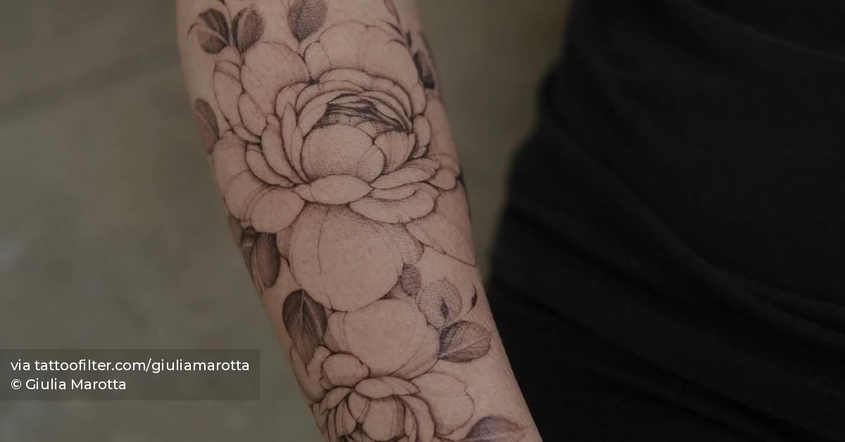 Illustrative style peonies tattooed on the forearm.