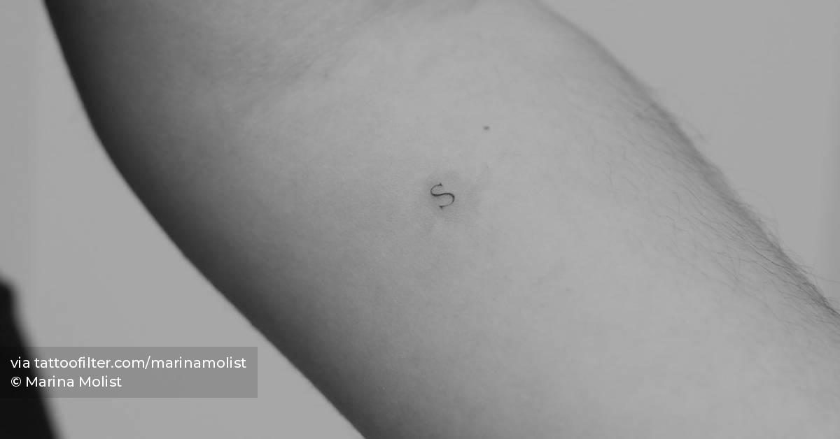 Tiny minimalistic letter "S" tattoo done on the inner