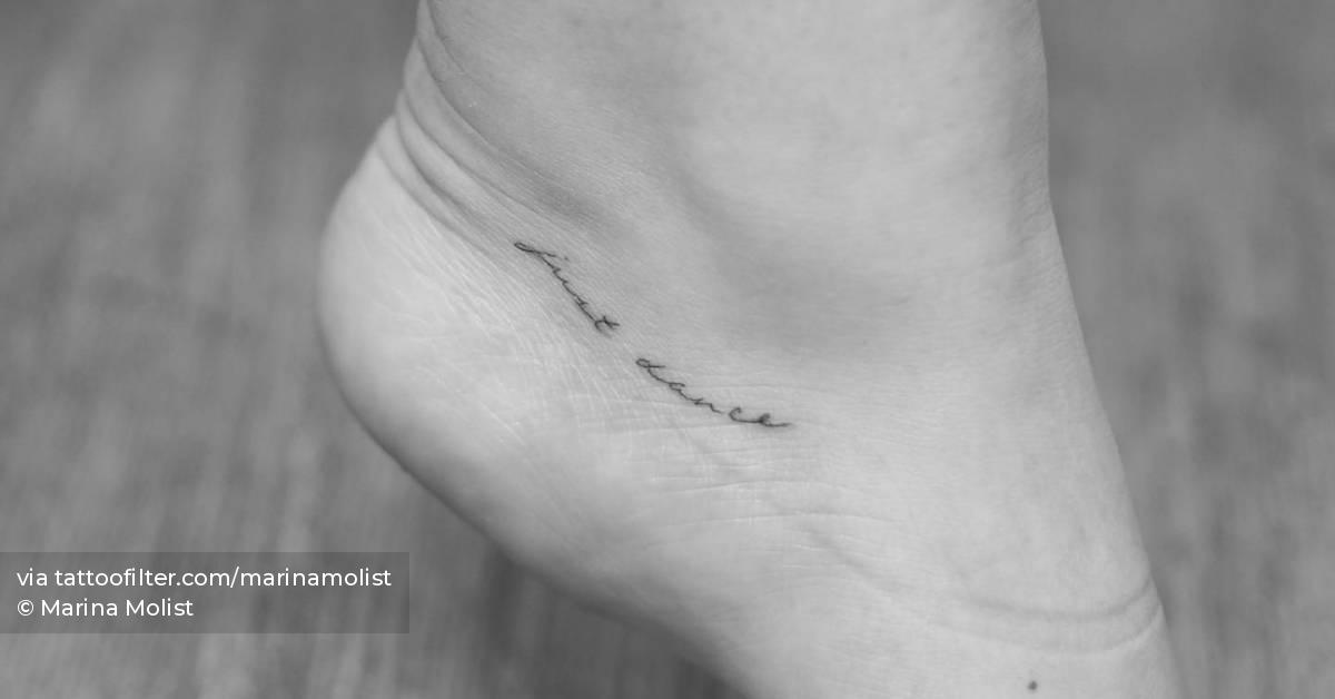 "Just dance" lettering tattoo done on the ankle.