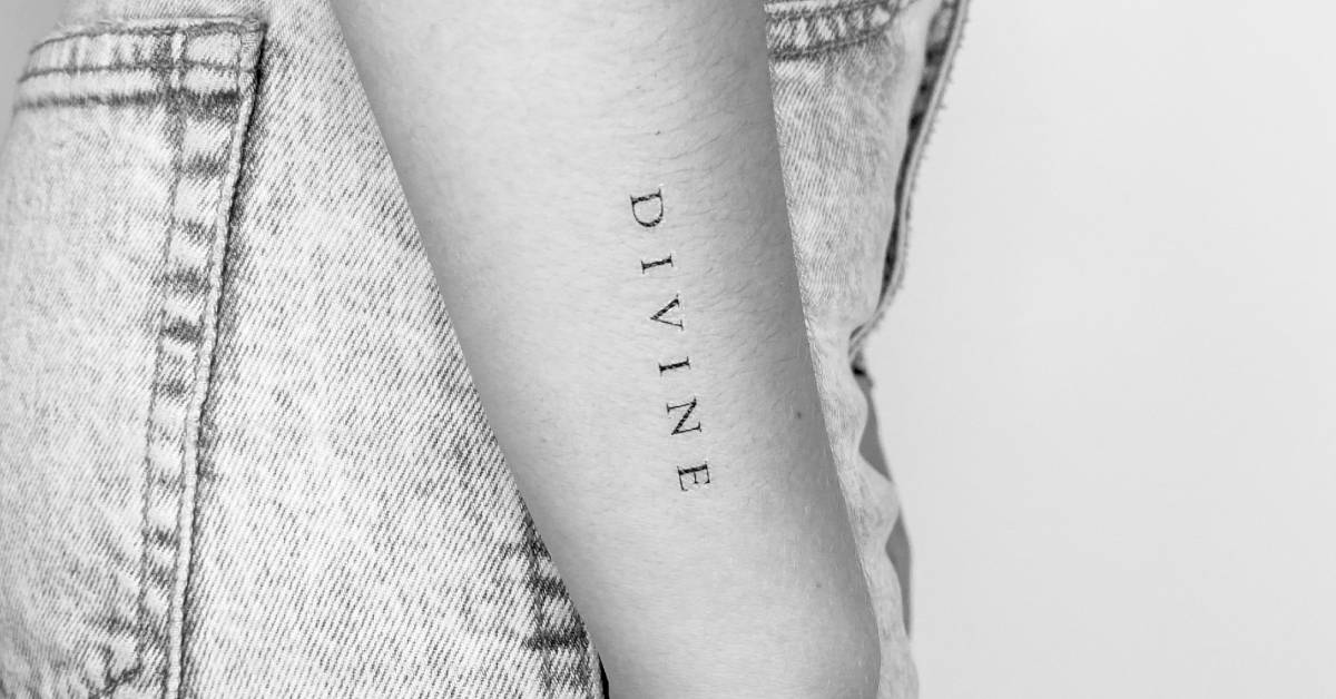 "Divine" temporary lettering tattoo located on the