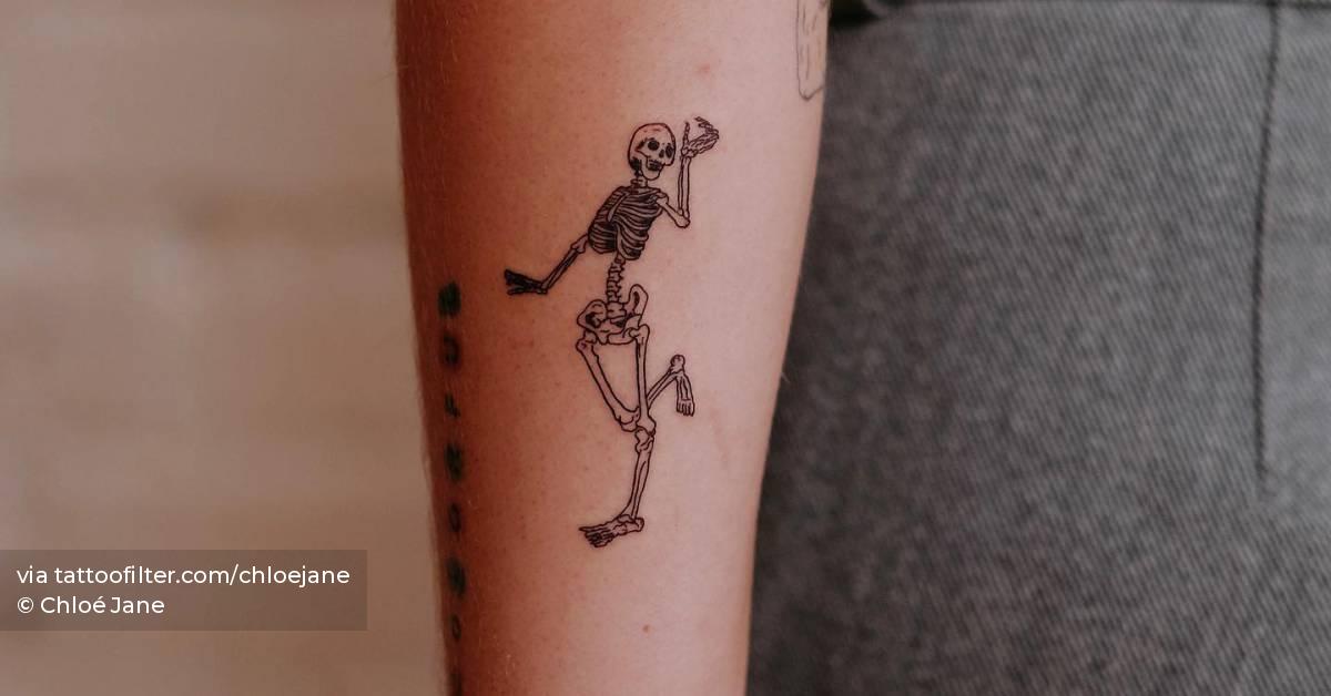 Dancing skeleton tattoo located on the forearm,